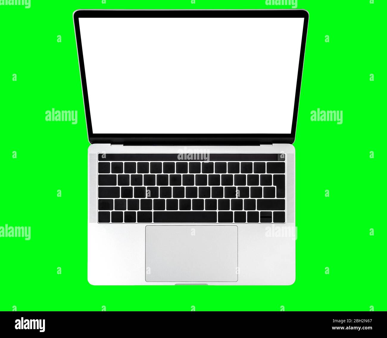 Laptop computer keyboard with white screen isolated on green background ...