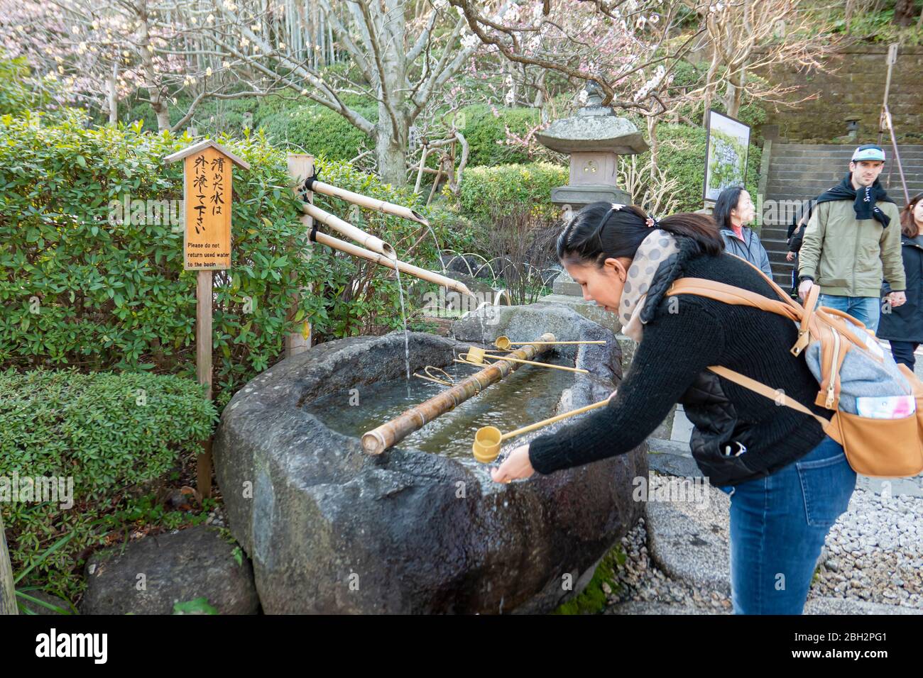 A holy fountain in thegarden of Hasedera temple full of visitors to see ...