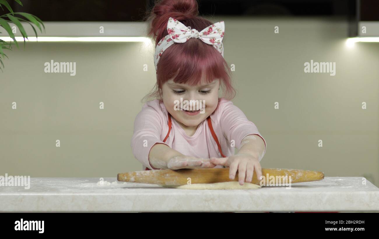 Cooking homemade pizza. Little child girl in the kitchen dressed in ...