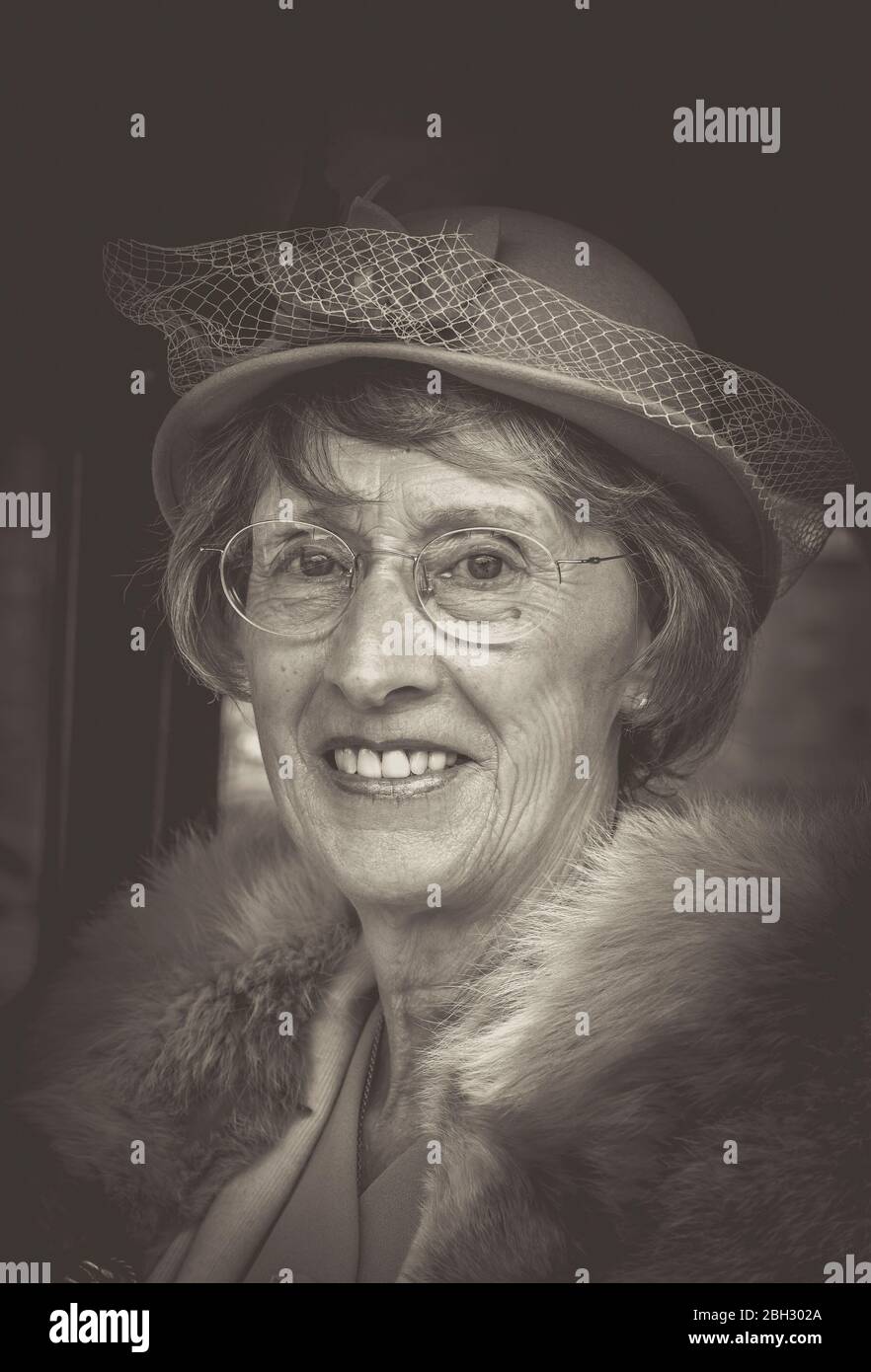 Close up monochrome portrait of 1940s woman, ww2 woman, in posh hat ...