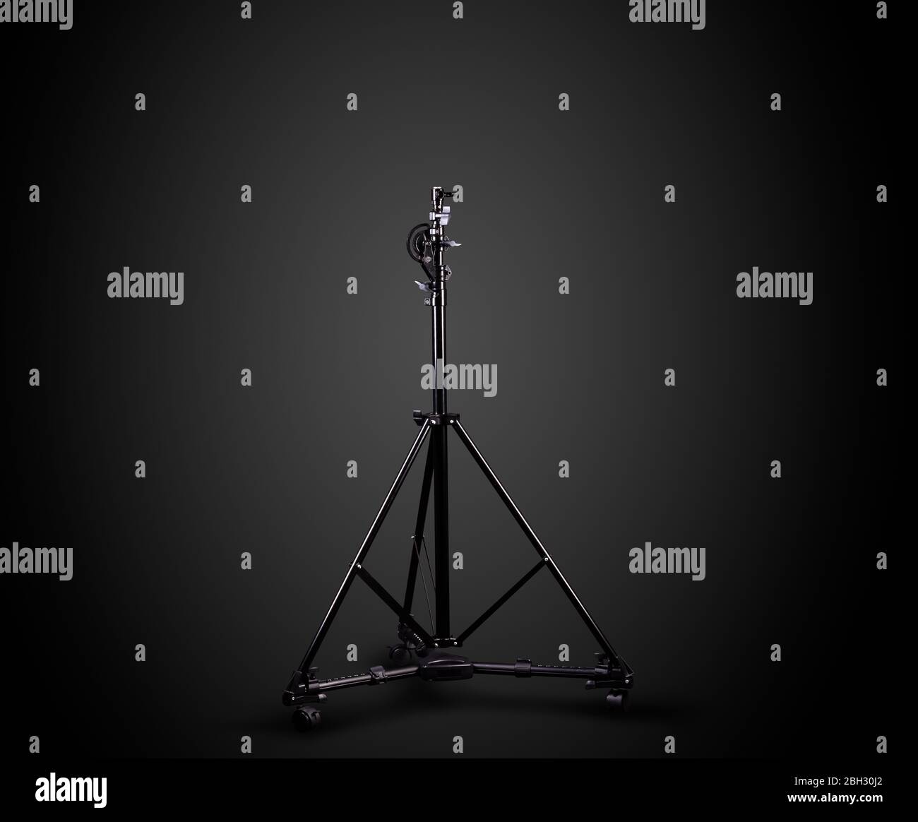 Studio lighting stands isolated on the black background with clipping ...