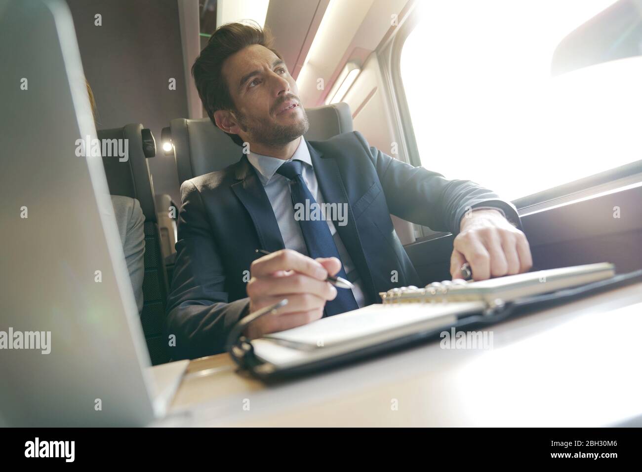 businessman working on a train in business class Stock Photo - Alamy