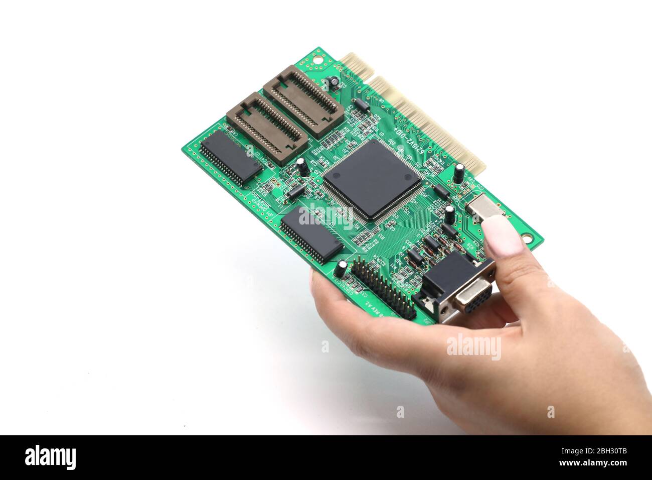 woman hand holding green computer chip isolated on a white background ...