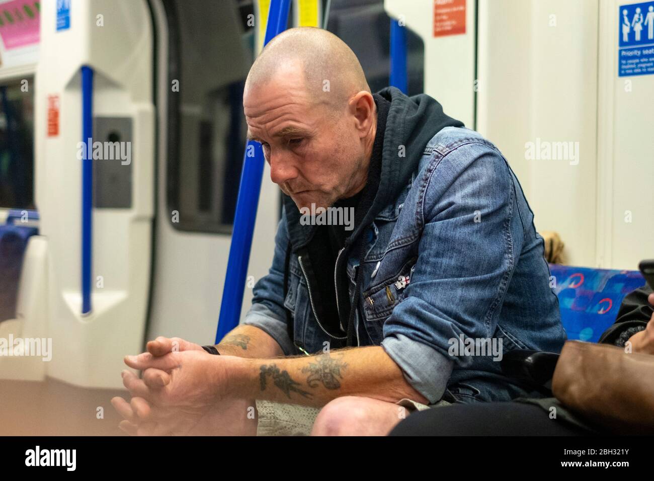 Profile portrait of a man leaning forward on his seat on the London ...