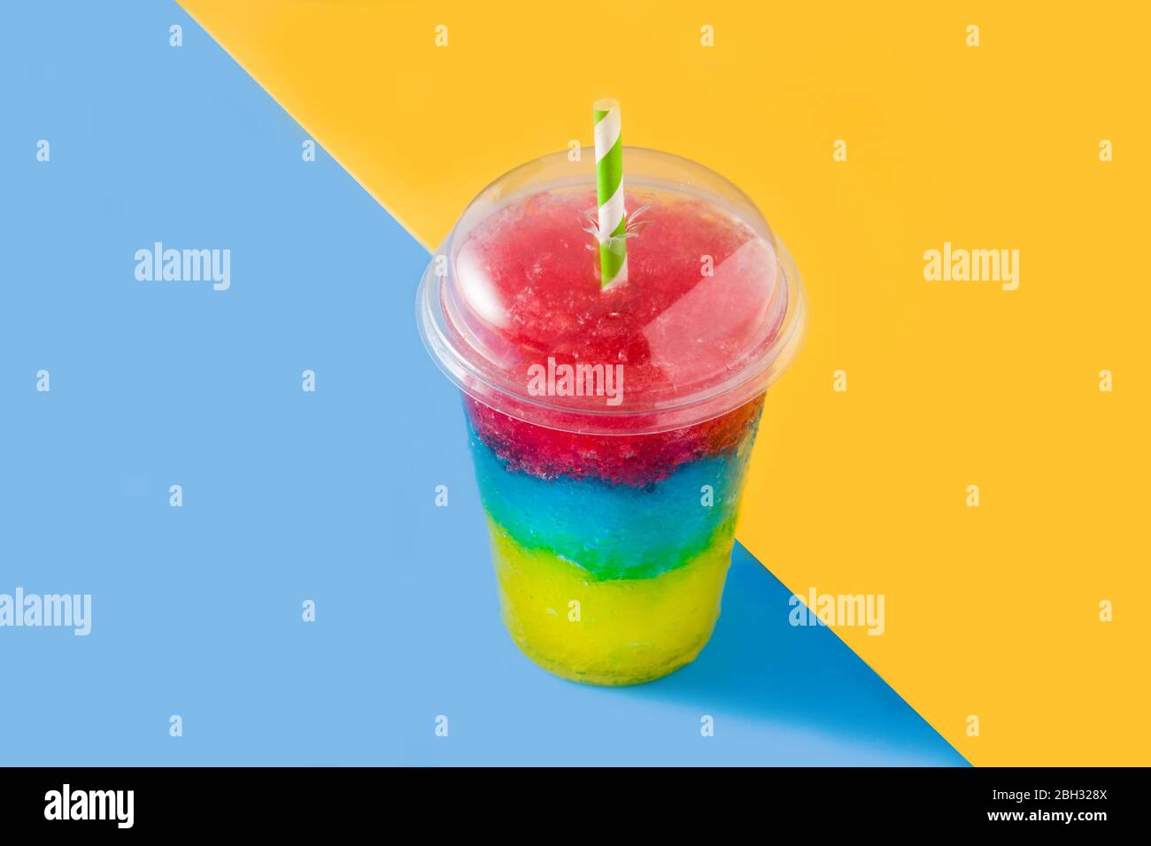 Colorful slushie of differents flavors on yellow and blue background ...