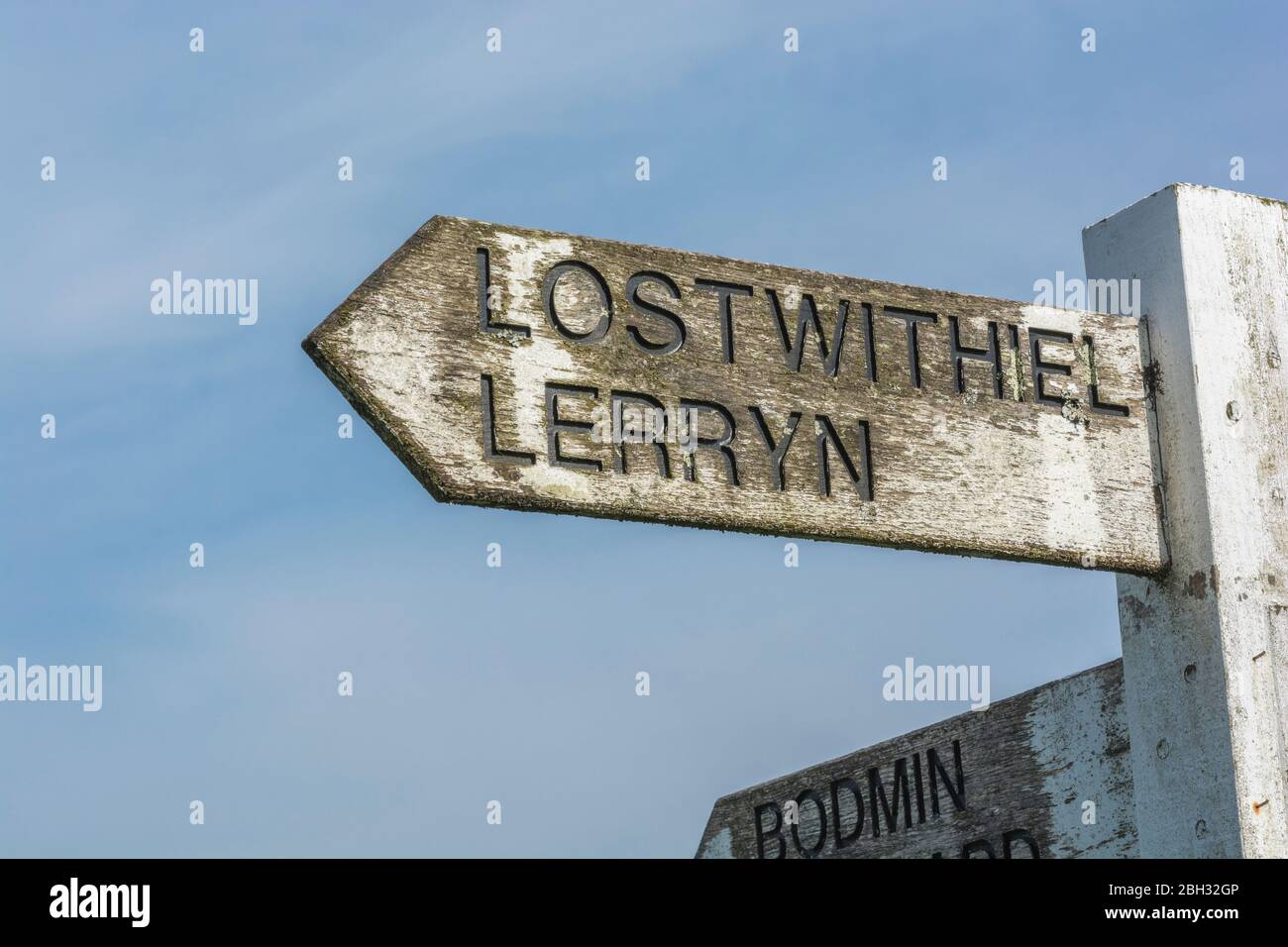 Local rural Cornish road sign to Lostwithiel and Lerryn - set against sunny blue Springtime sky ...