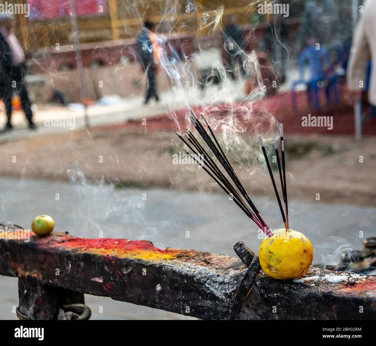 Lit oil and butter candles scatter their sacred and fragrant smoke on ...
