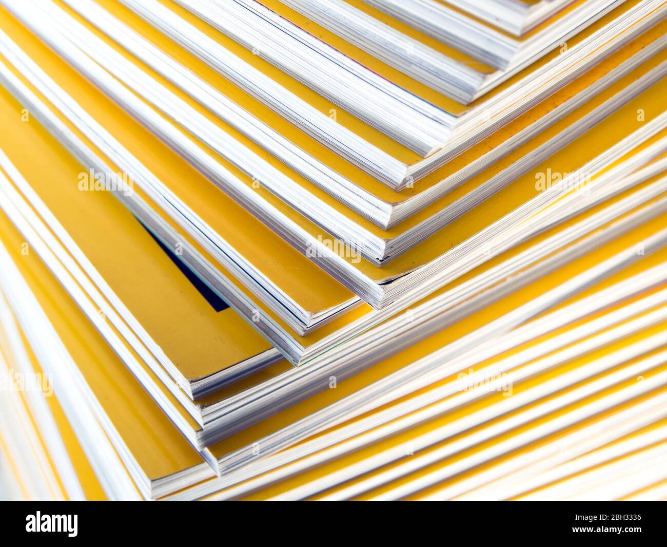 Stack of yellow color monthly magazine Stock Photo - Alamy