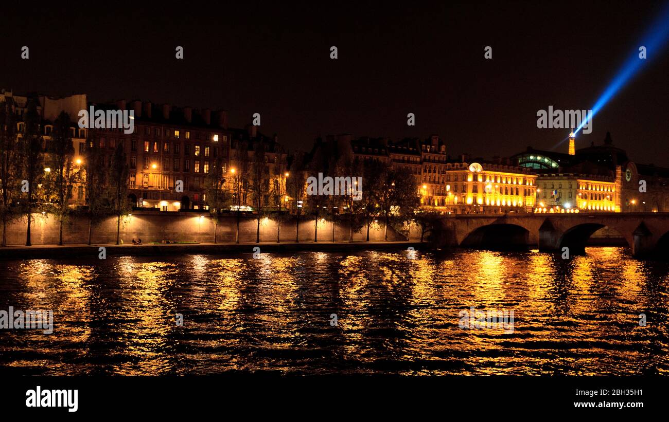 The illuminated banks of the river Seine at night with the Musee d ...