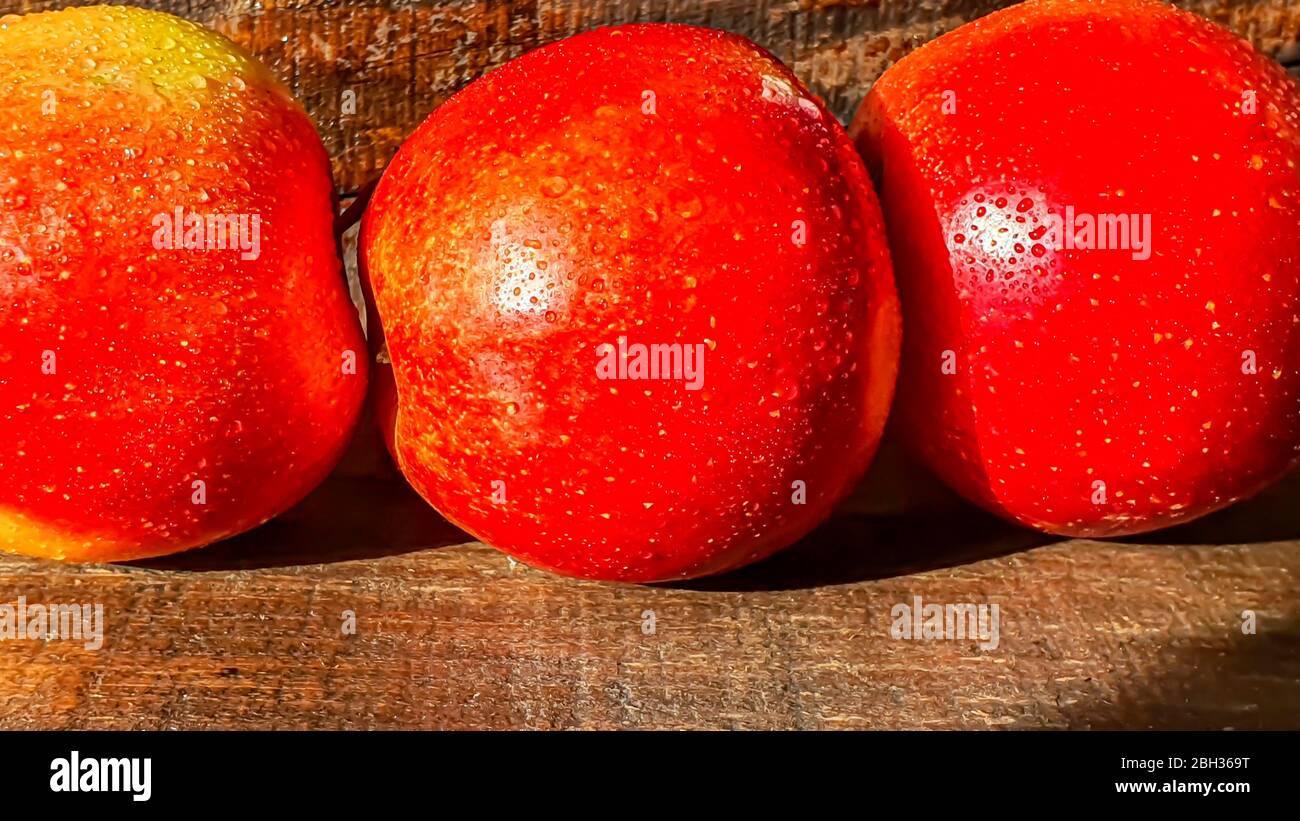 Ripe red apples on a wooden background. Vitamins and minerals, healthy ...