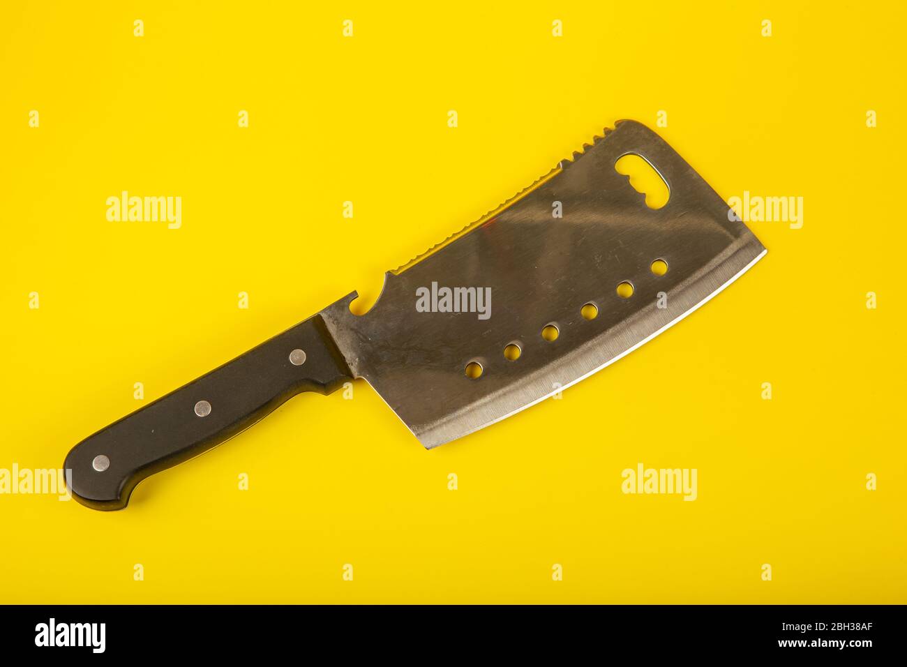 Butcher knife with wooden handle on yellow background Stock Photo - Alamy