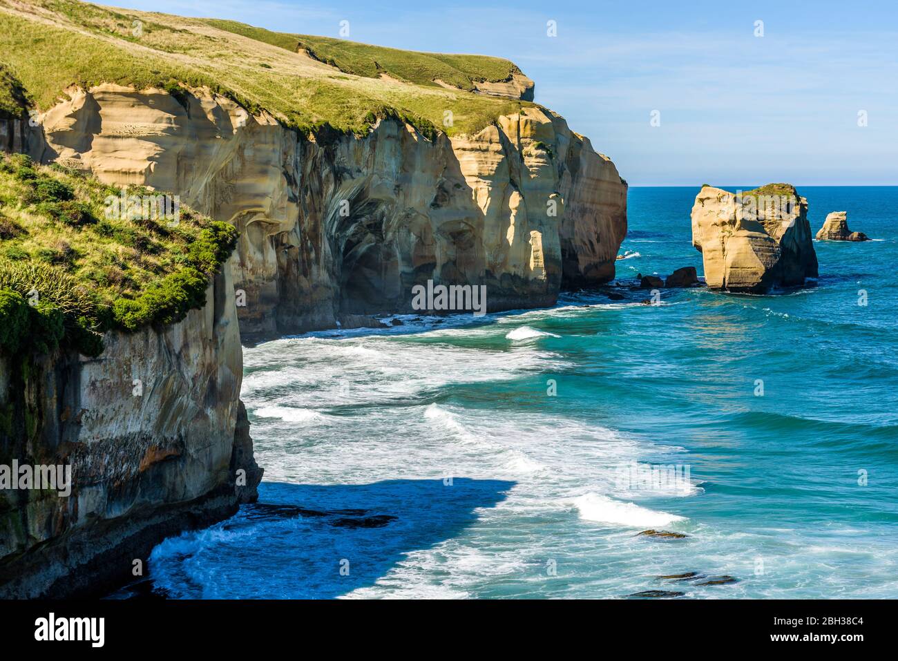 Sculpted cliffs, eroded rock formations and rough sea waves at Tunnel ...