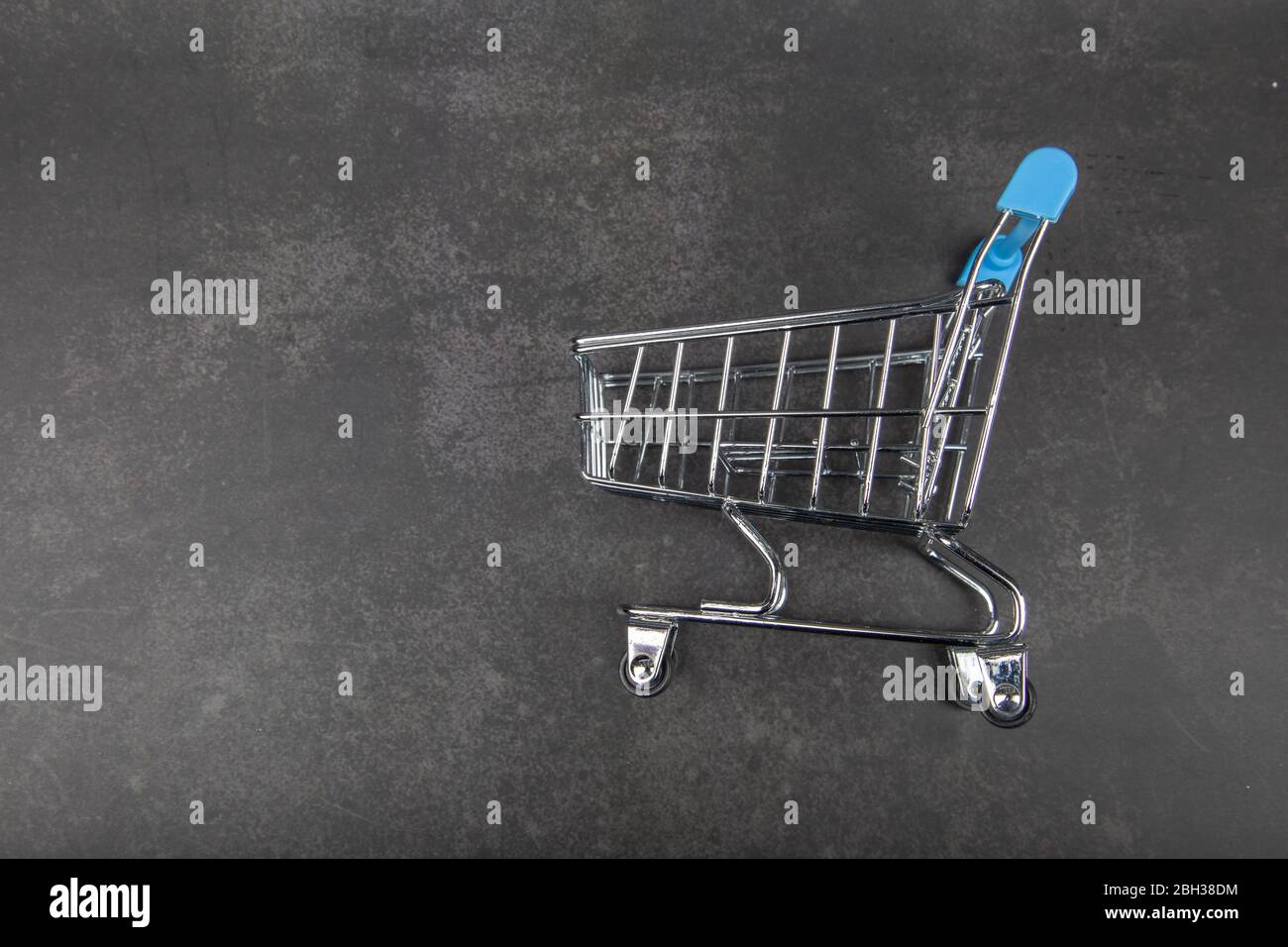 Empty Groceries trolley on grey background Stock Photo - Alamy