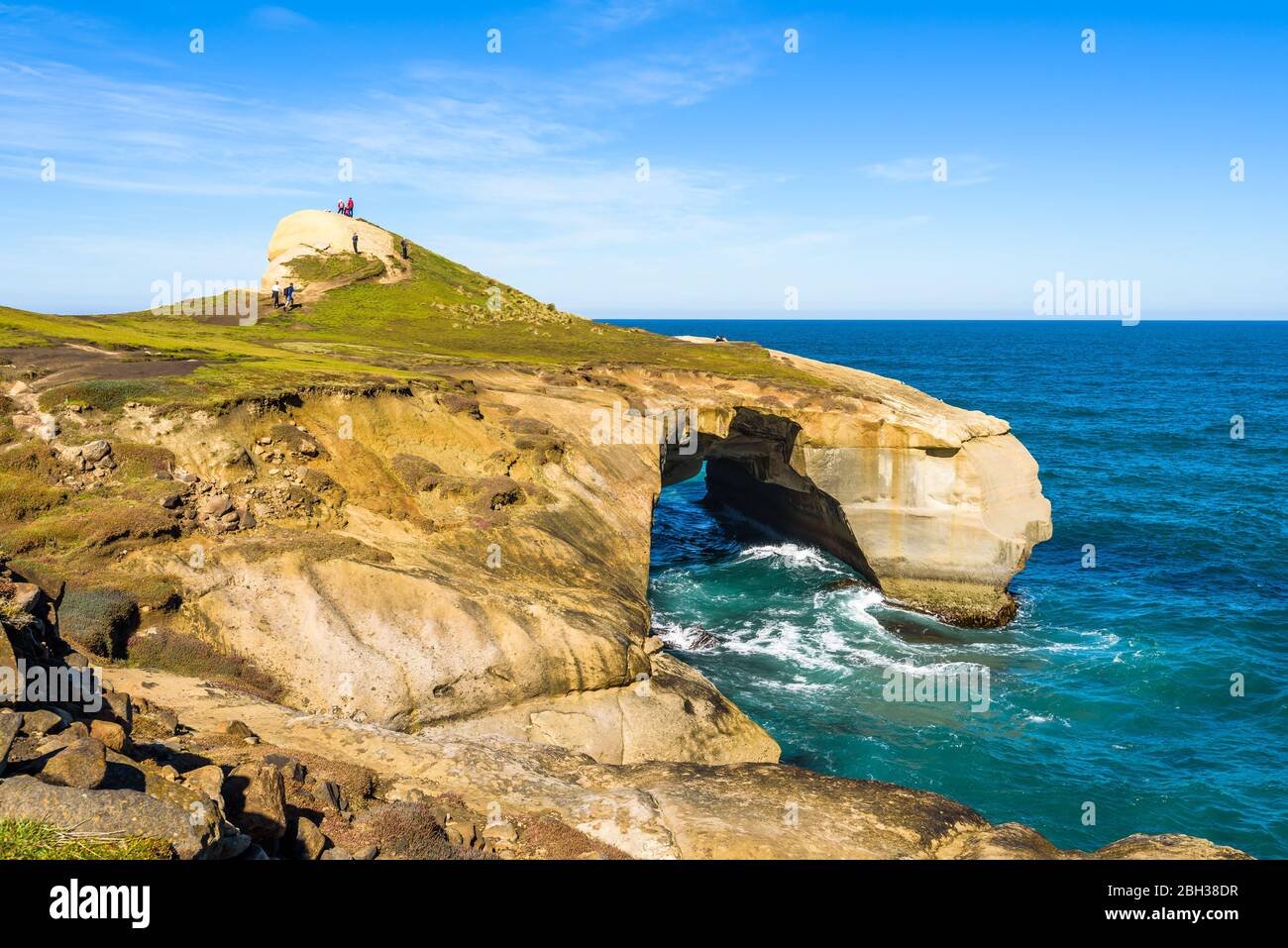 Sculpted cliffs, eroded rock formations and rough sea waves at Tunnel ...