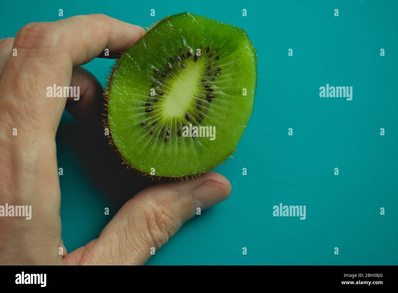 hand securing kiwi Stock Photo - Alamy