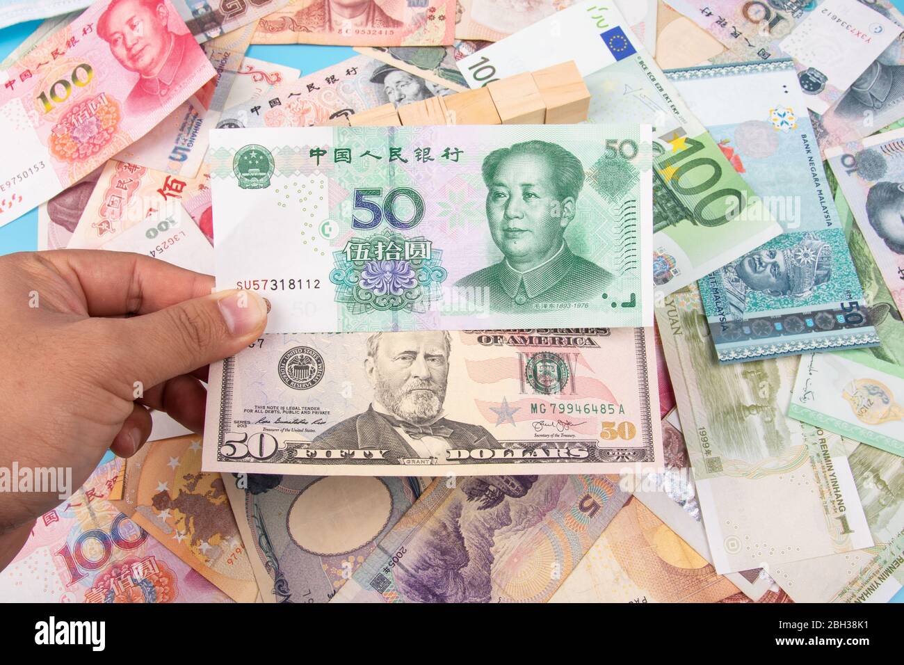 Man Hand holding Bank Note of YUAN RMB and USD Dollar with World ...