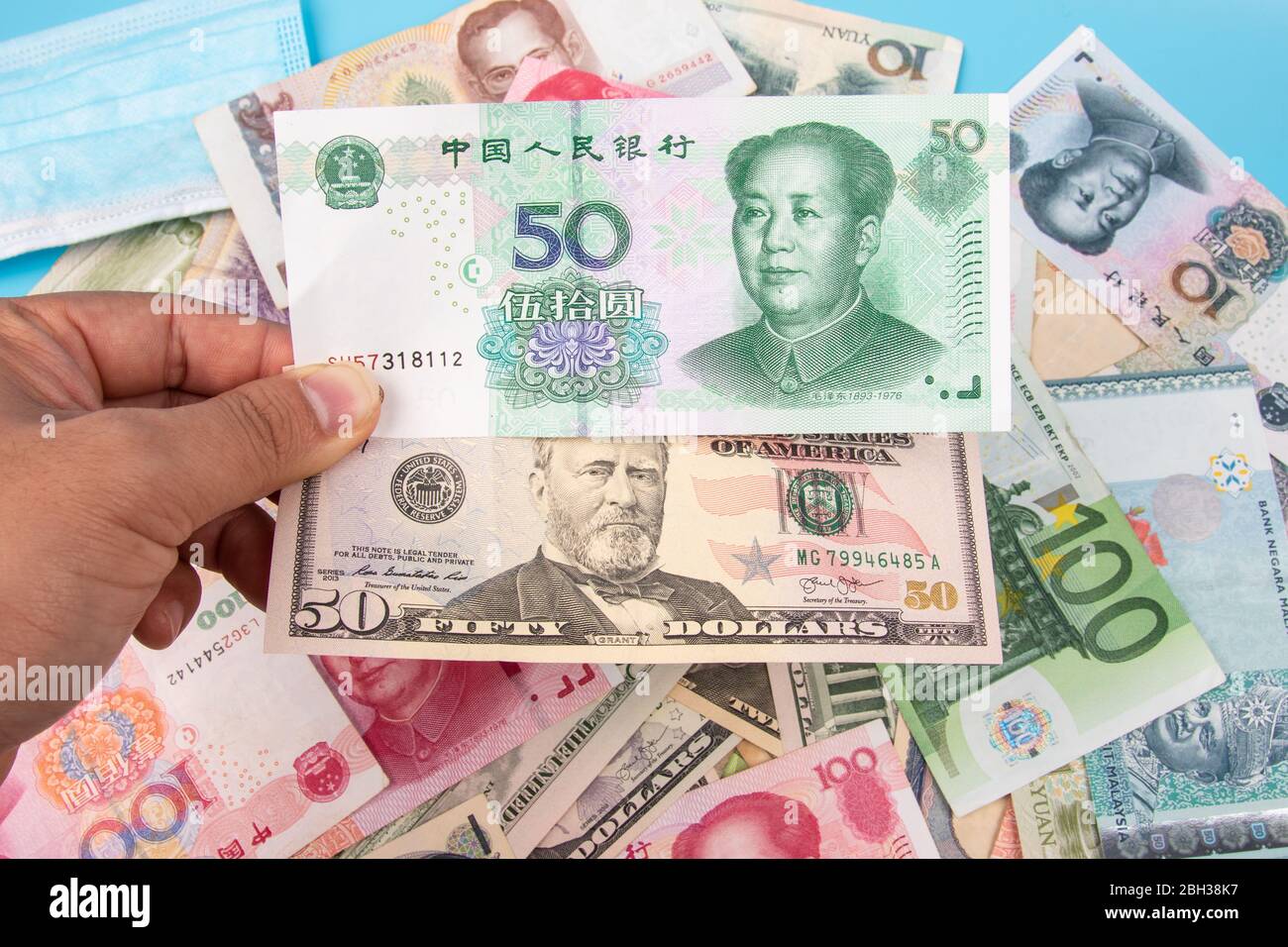 Man Hand Holding Bank Note Of YUAN RMB And USD Dollar With World Man Hand Holding Bank Note Of YUAN RMB And USD Dollar With World