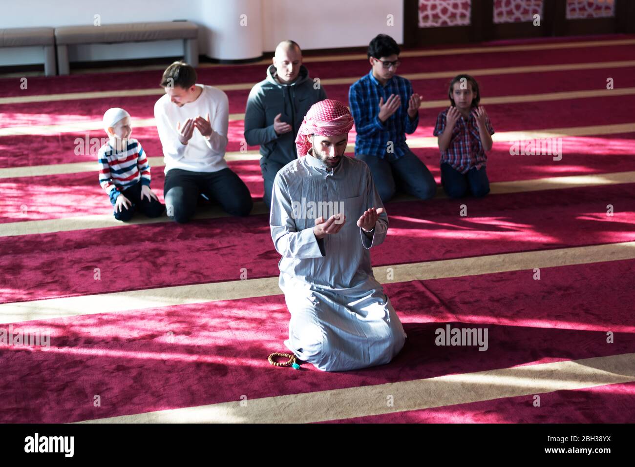 Group of young Muslim people praying. Muslim prayers doing a pray ...
