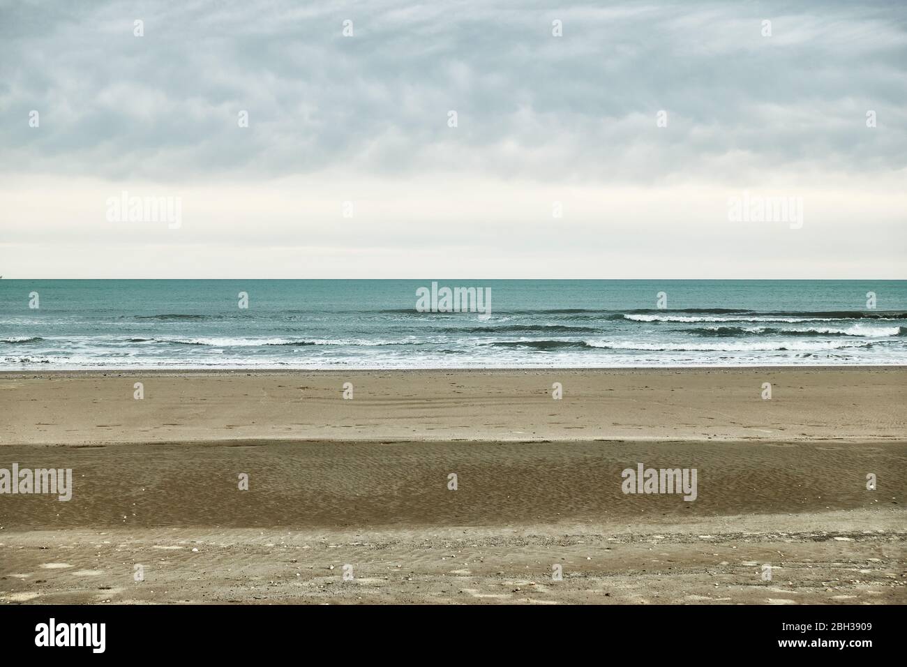 Minimalistic striped landscape with sandy beach, sea and cloudy sky ...
