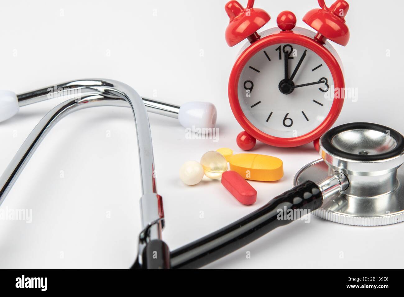 A picture of stethoscope, medicines and clock. It is for medical ...