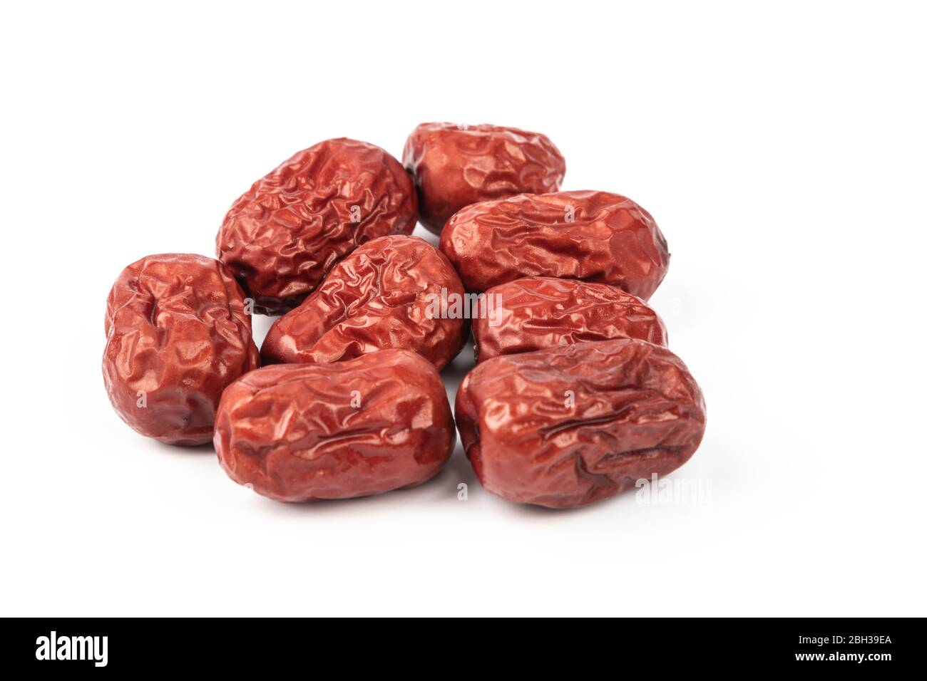 A bowl of Chinese dried red date fruit on white background. Keywords ...