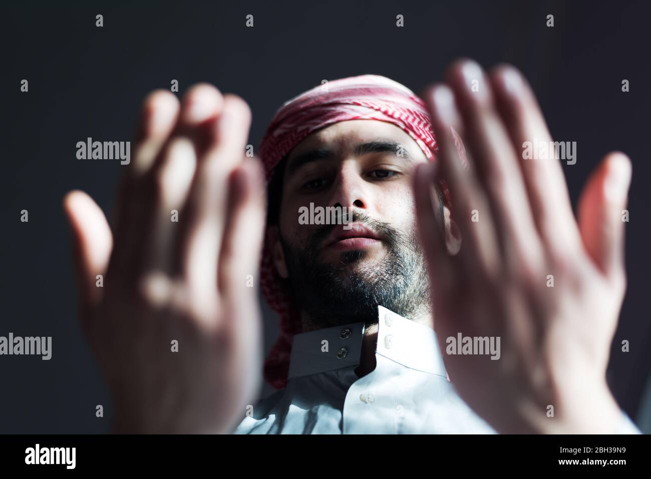 Young Arabic Muslim man praying. Doing a dailly pray inside modern ...