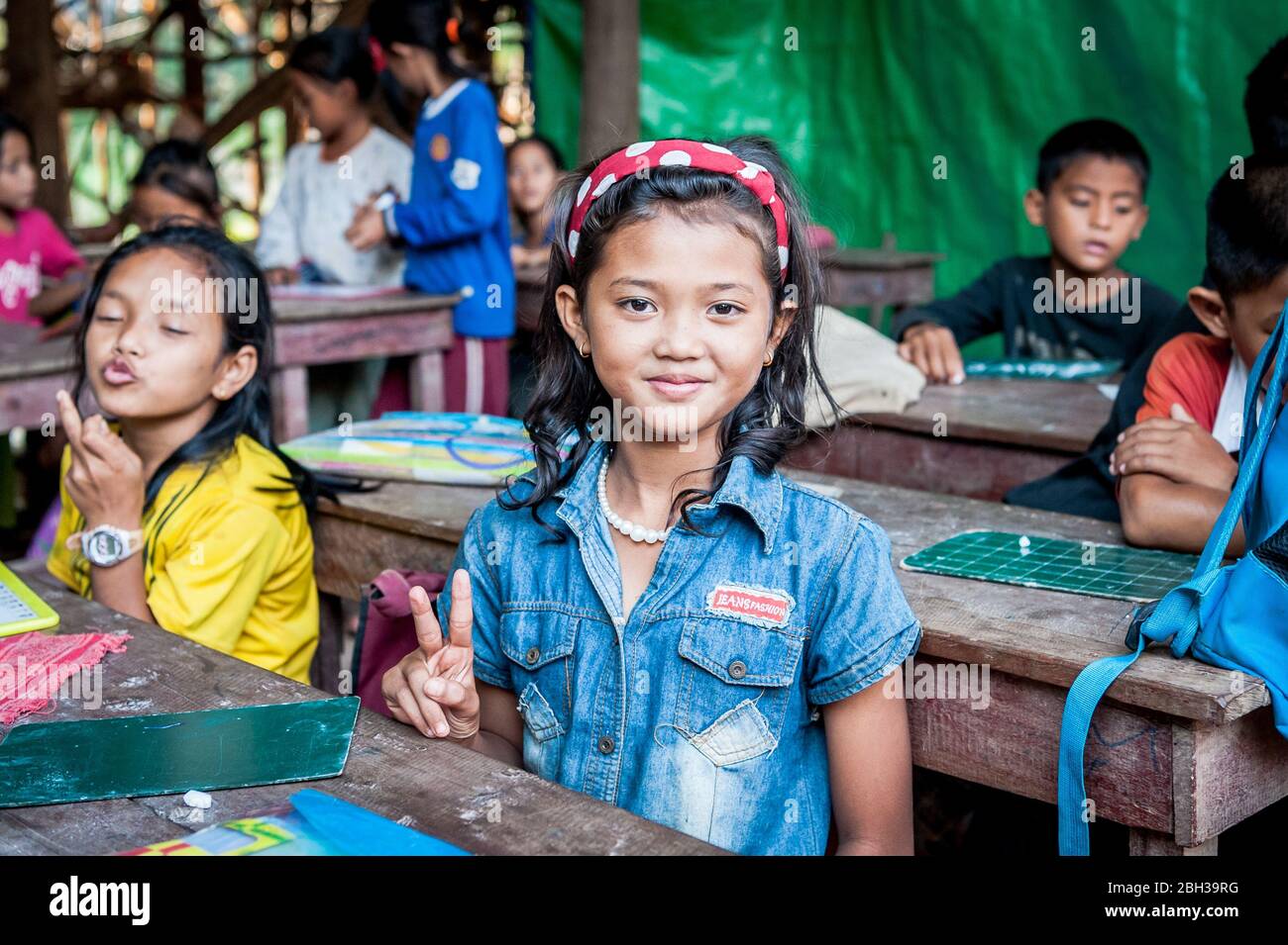 Cambodian school children smile for the camera in a school in the ...
