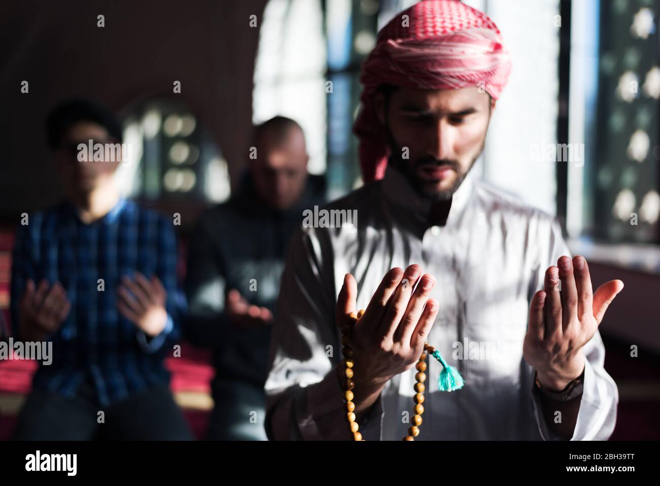 Group of young Muslim people praying. Muslim prayers doing a pray ...