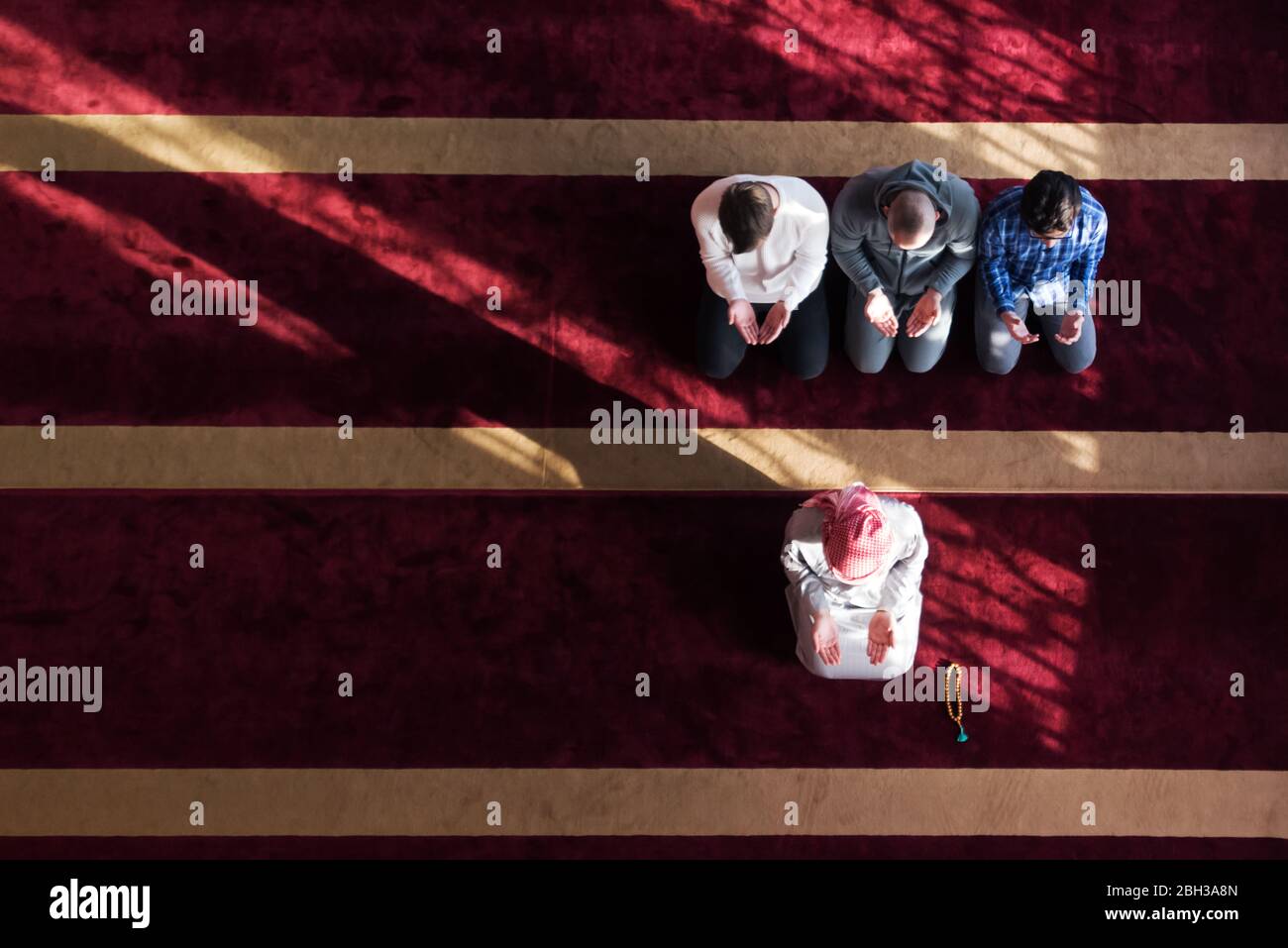 Group of young Muslim people praying. Muslim prayers doing a pray ...