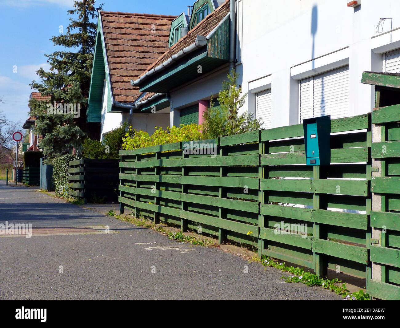 Stained green wooden fence. horizontal planks. vertical wooden posts ...