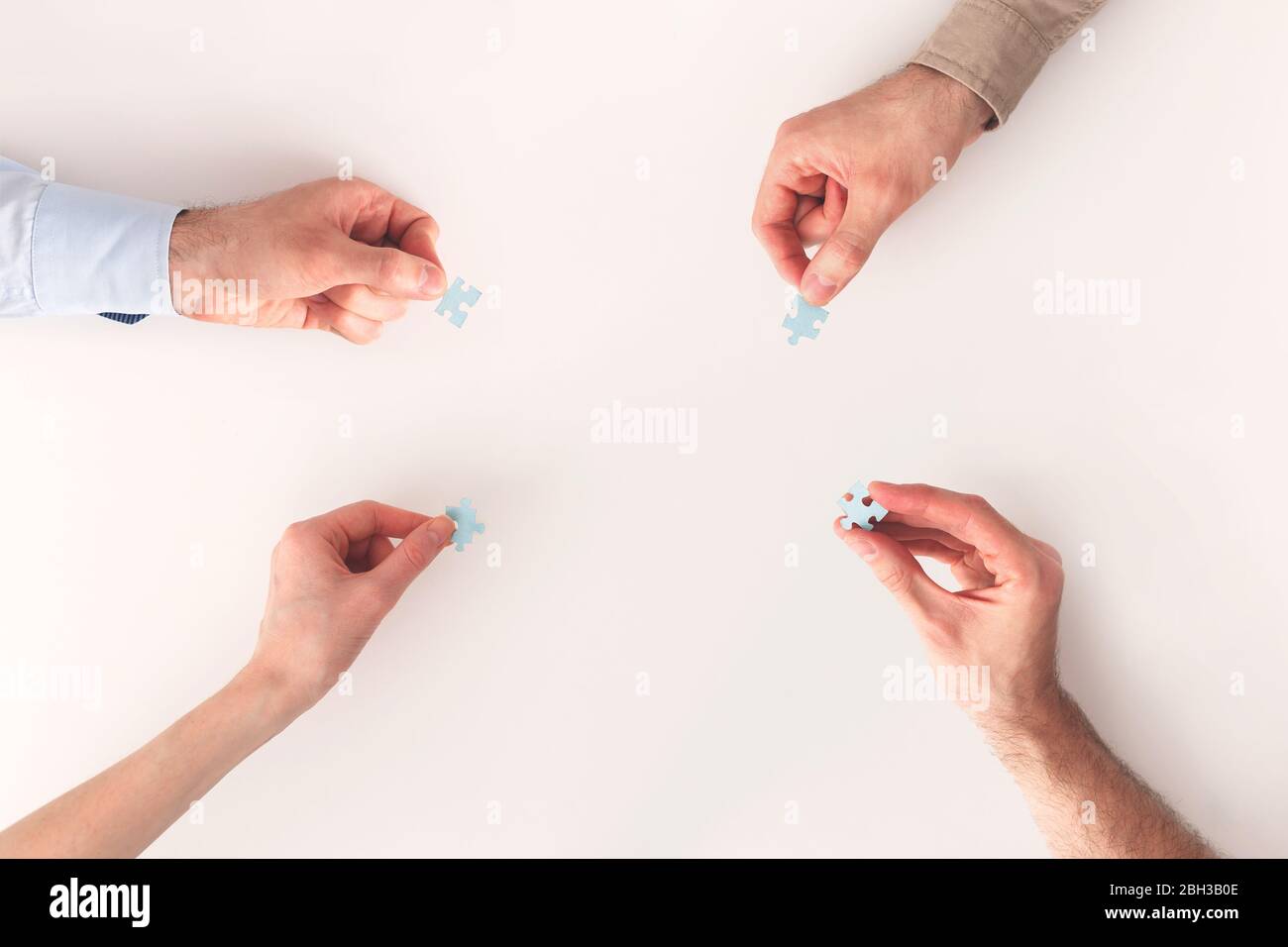 Hands with puzzle items isolated on white background. Team problem ...