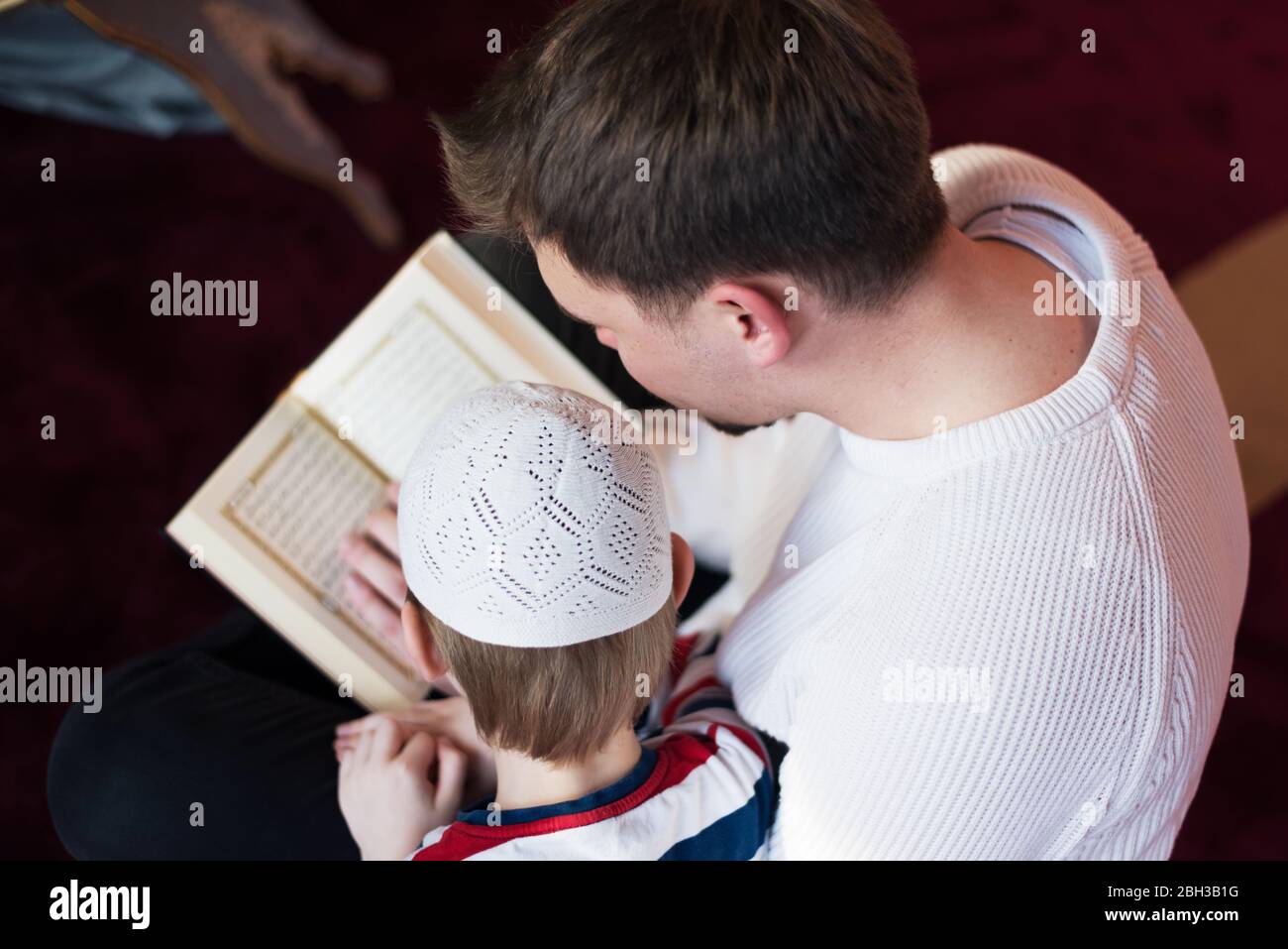 Muslim father and son praying together. Muslim dad and son praying in ...