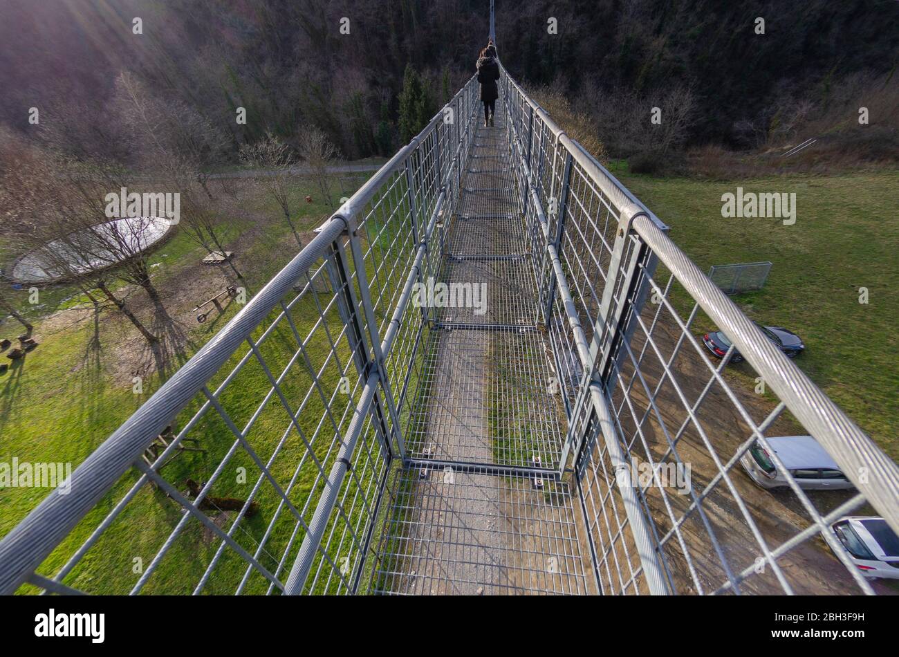 Suspension bridge walkway seen from above in the foreground Stock Photo ...
