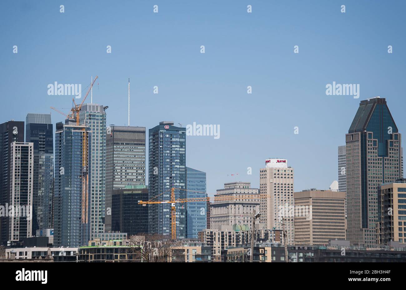 Montreal, Can. 23rd Apr, 2020. Cranes are shown next to the skyline of ...