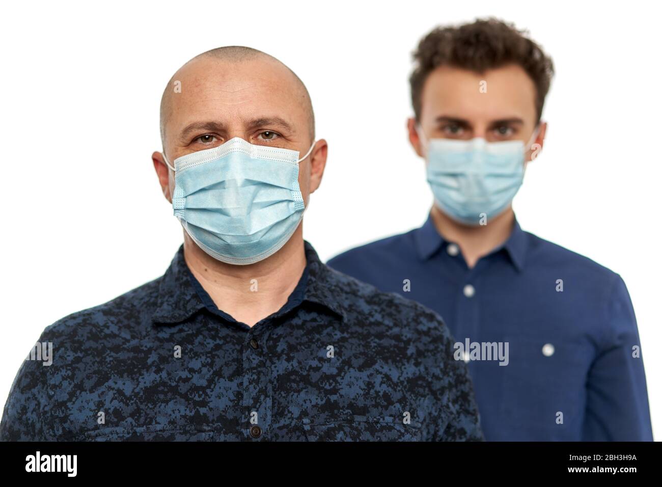 Two men wearing surgical masks isolated on white background Stock Photo ...