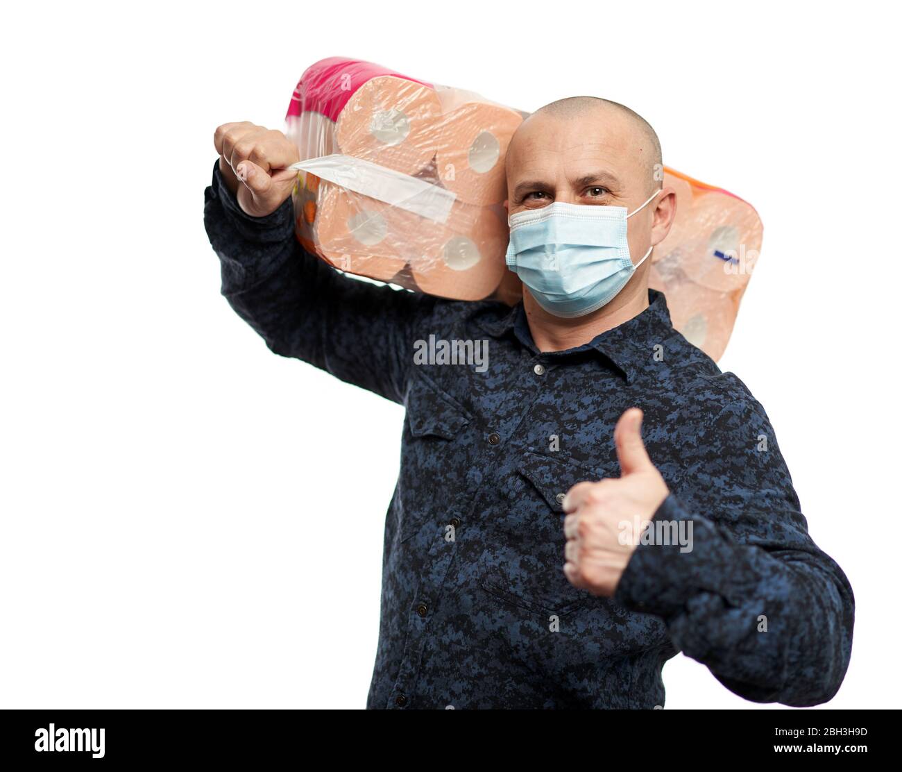Man wearing a face mask and a huge bag of toilet paper Stock Photo - Alamy