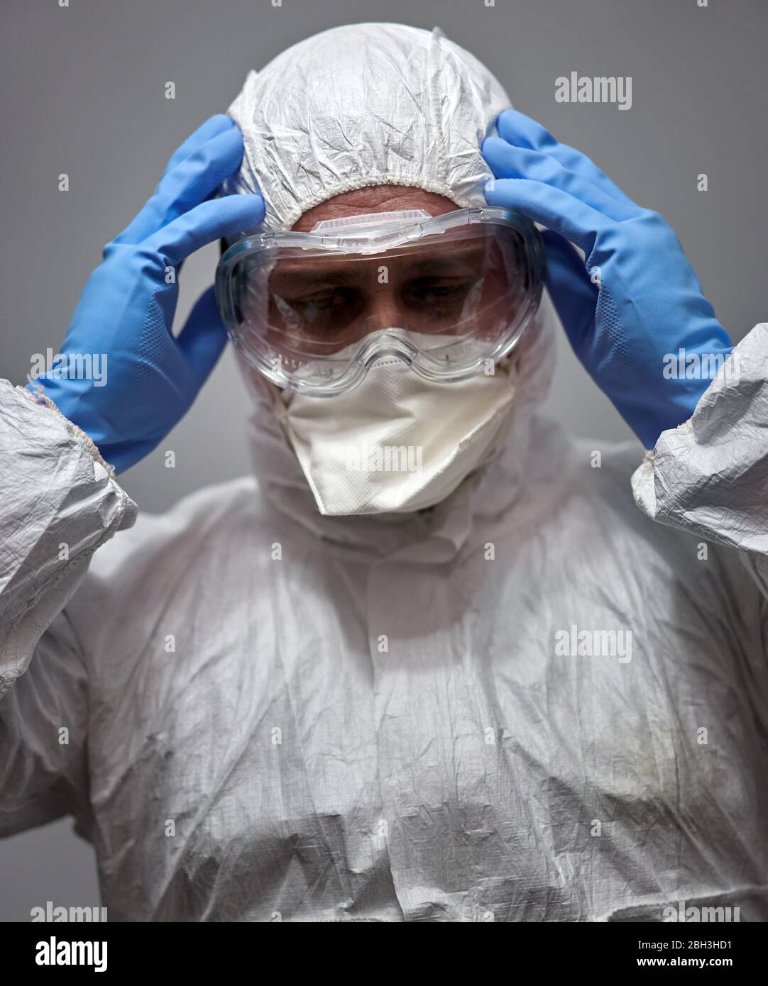 Overwhelmed health worker in overall protection suit Stock Photo - Alamy