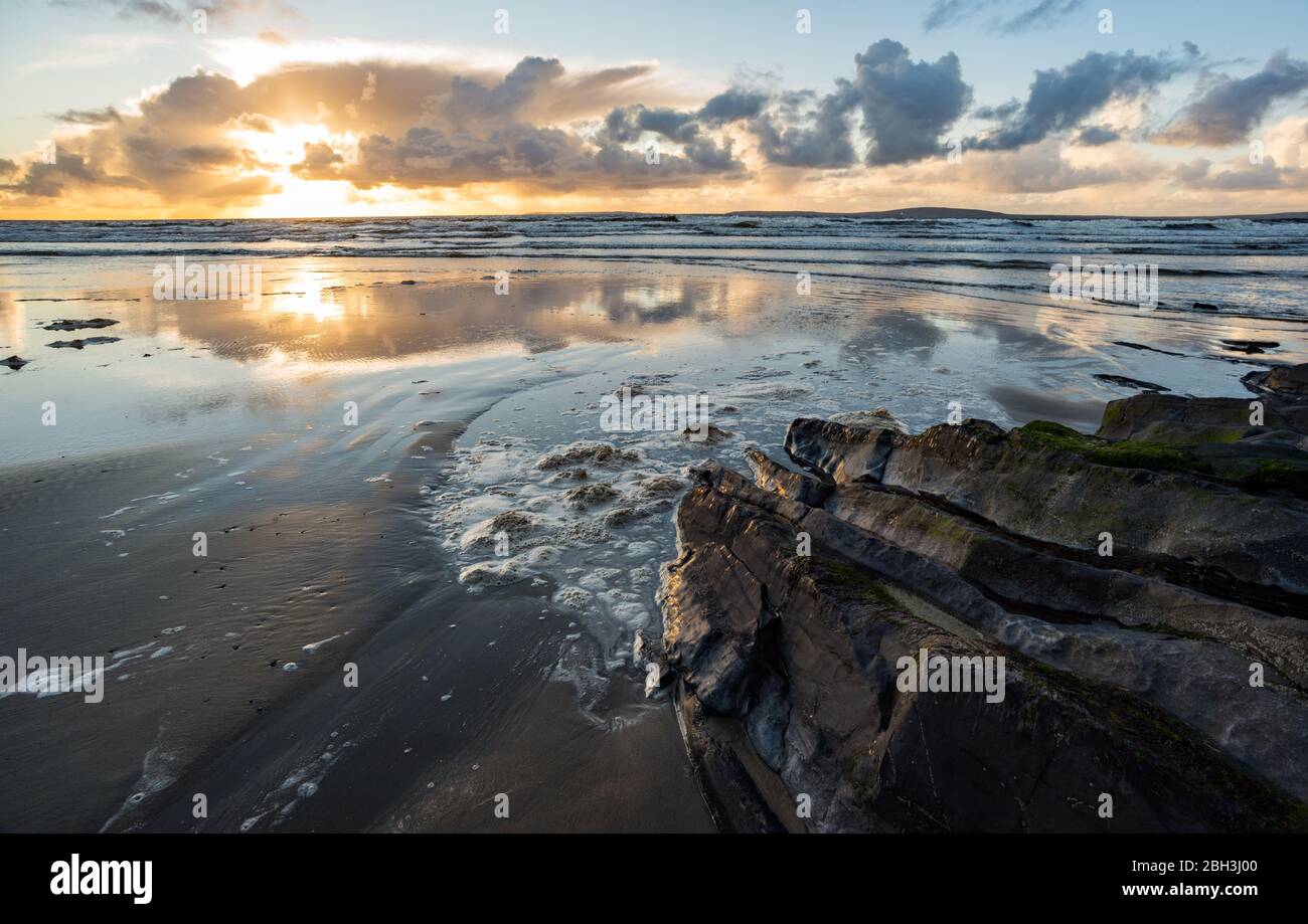 Dramatic sunset sky reflection on empty beach, wild atlantic way on ...