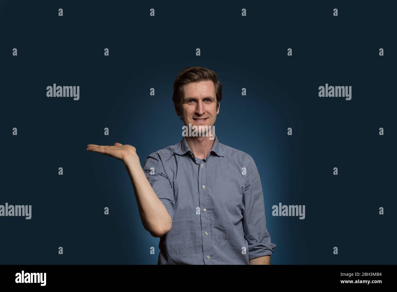 Man Holding Up Hand Open Palm Upwards and Smiling Stock Photo - Alamy