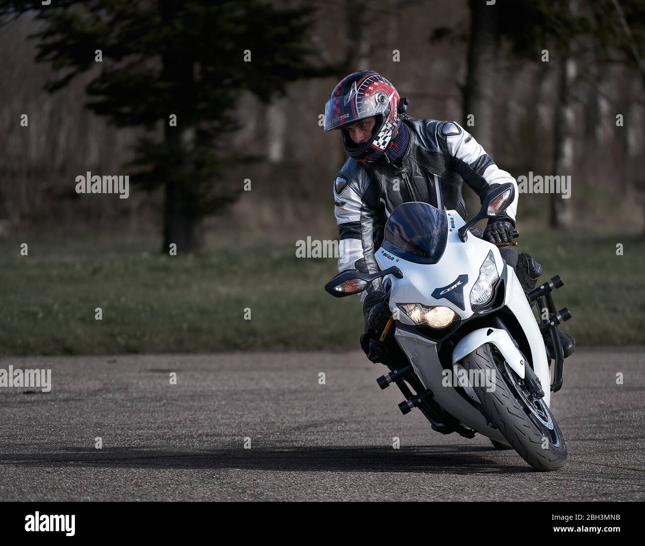 young man riding big bike motorcycle leaning curve on asphalt highways ...