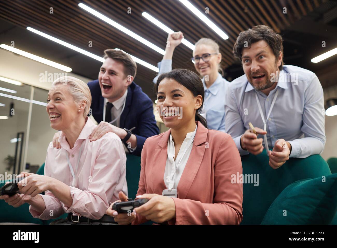 Group of business people playing in video game together during their ...