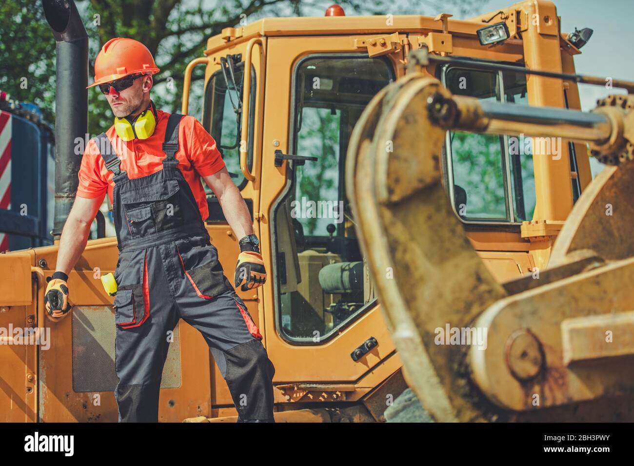 Construction Male Worker On Commercial Job Site With Heavy Duty ...