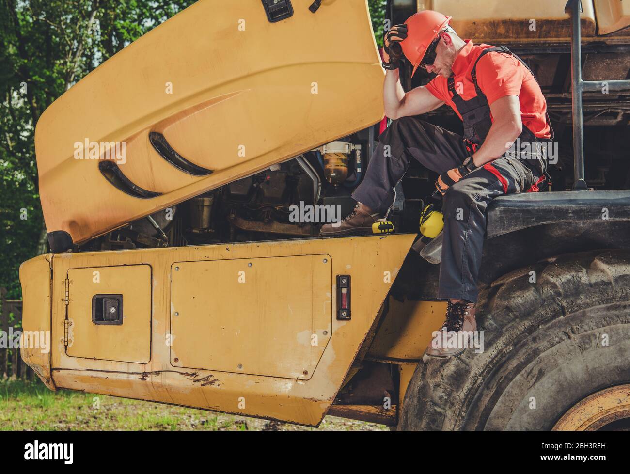 Heavy Equipment Repairman Thinking Of Solutions To Broken Engine Stock ...