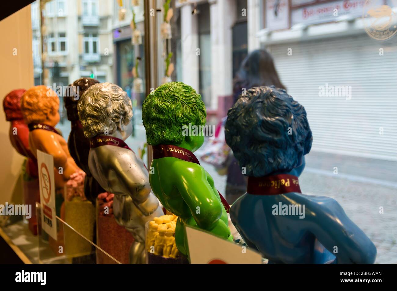 She turns heads: five colored statues of a boy looking at a passing ...