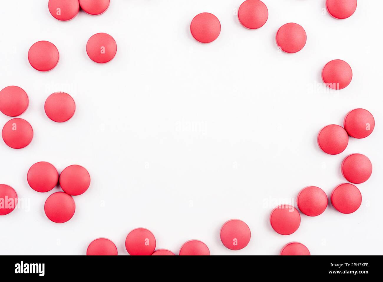 Red round tablets on a white background with a copyspace Stock Photo ...