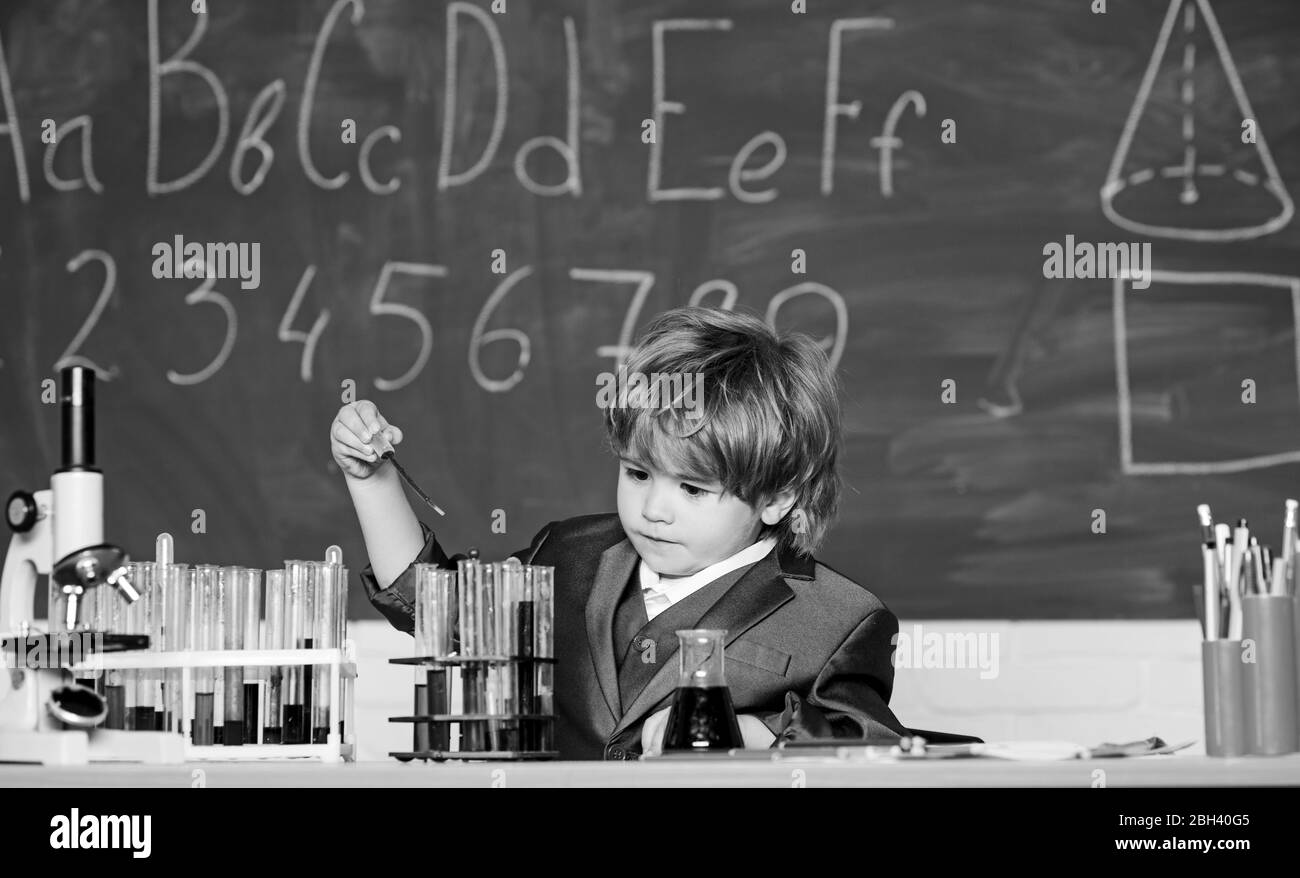 Back to school. Pupil looking through microscope . microscope at lab ...