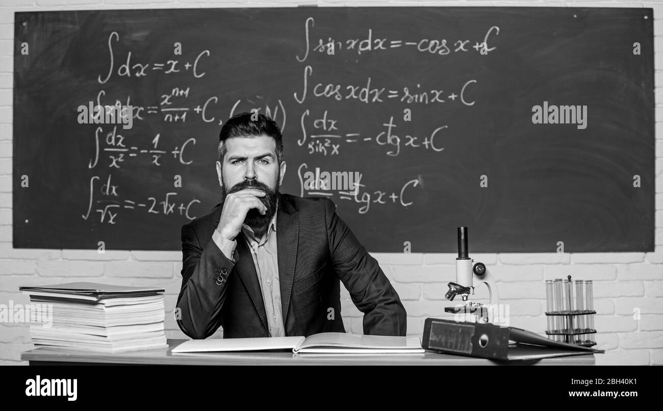 Thinking on serious problem. Serious teacher touching beard by hand ...