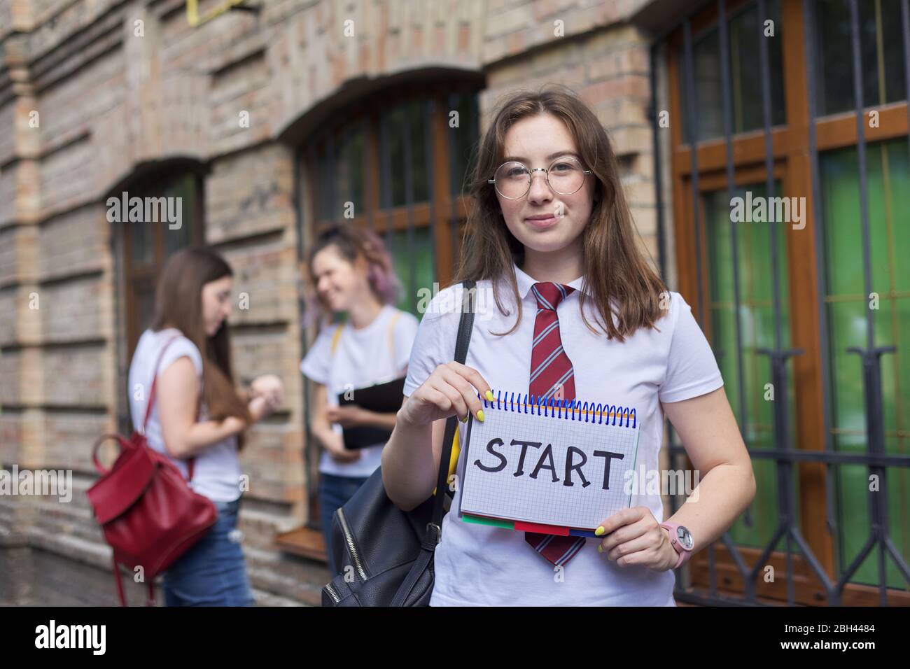Start. Girl student holds notebook with word start, beginning of ...