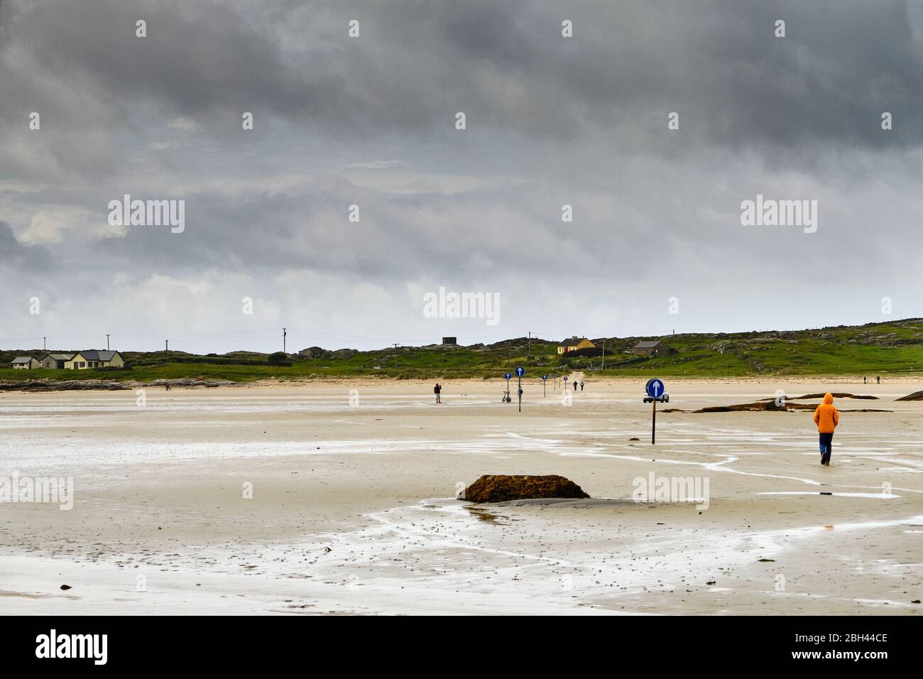 The large sandy strand to reach Omey Island by following the arrowed ...
