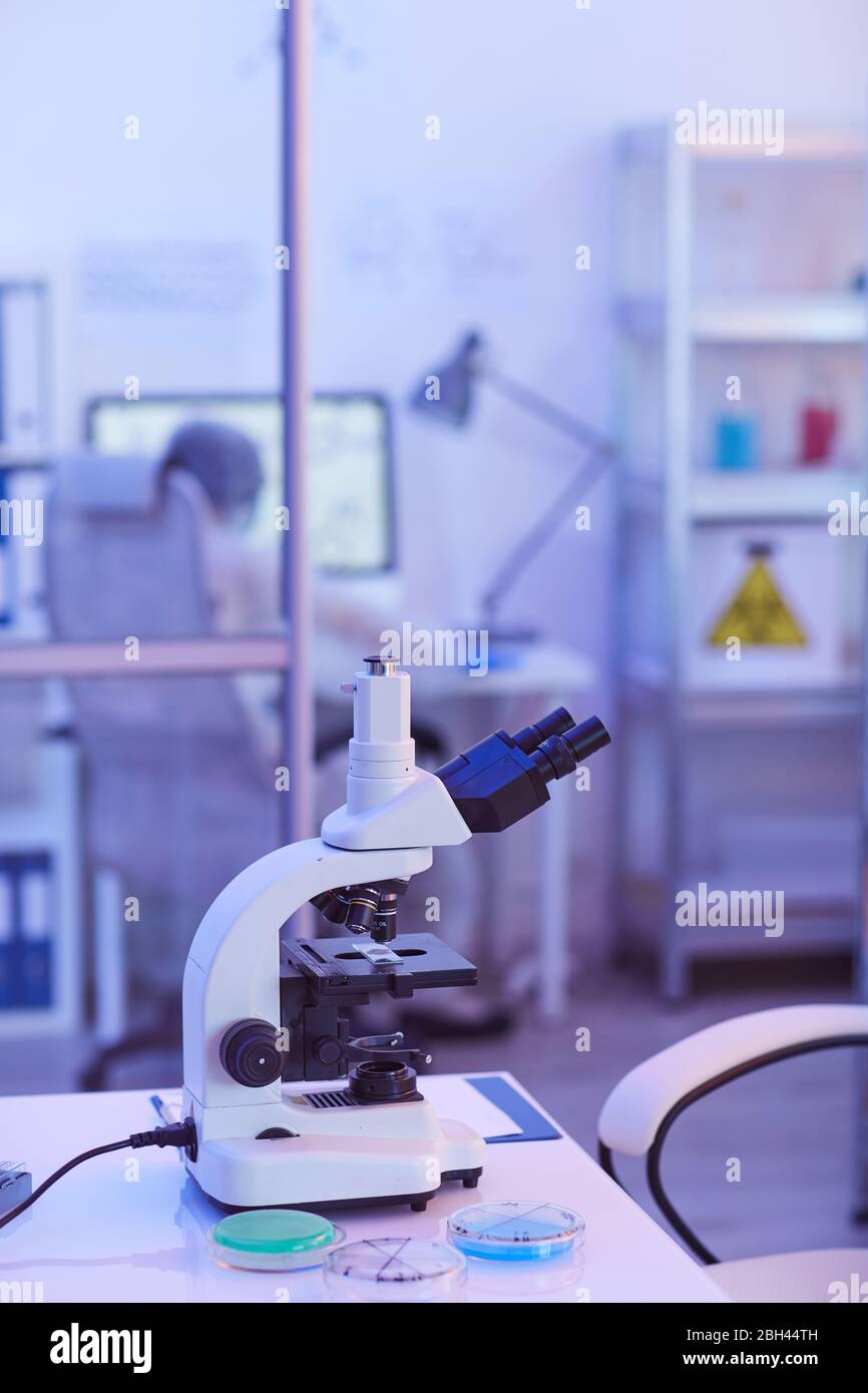 Scientist working microscope table hi-res stock photography and images ...